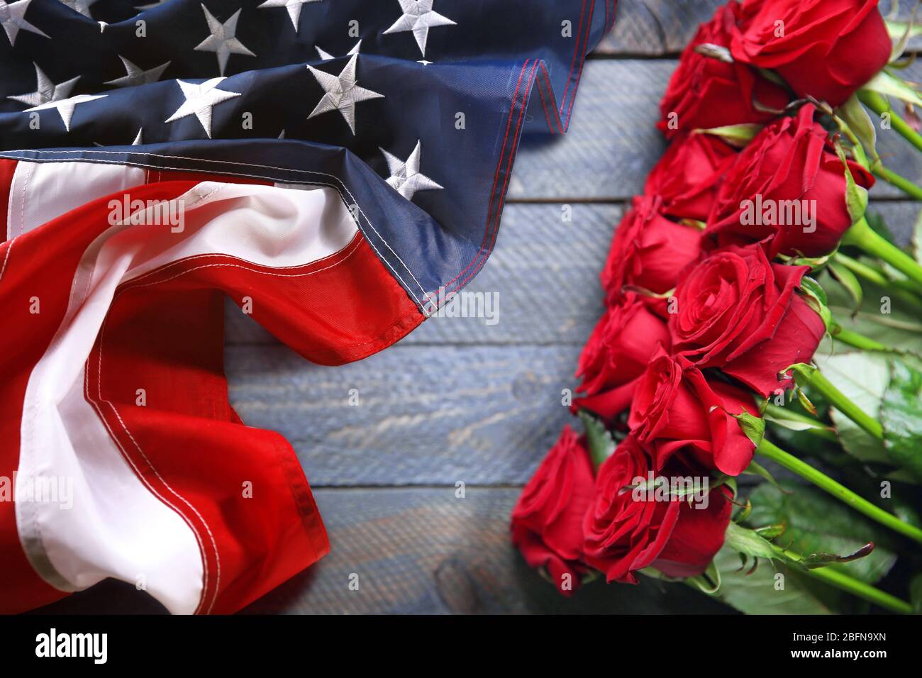 Roses and USA flag on wooden background. Symbol of America Stock Photo ...