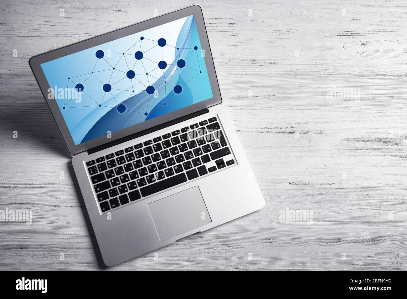 Laptop on white wooden background. Network design on screen Stock Photo ...