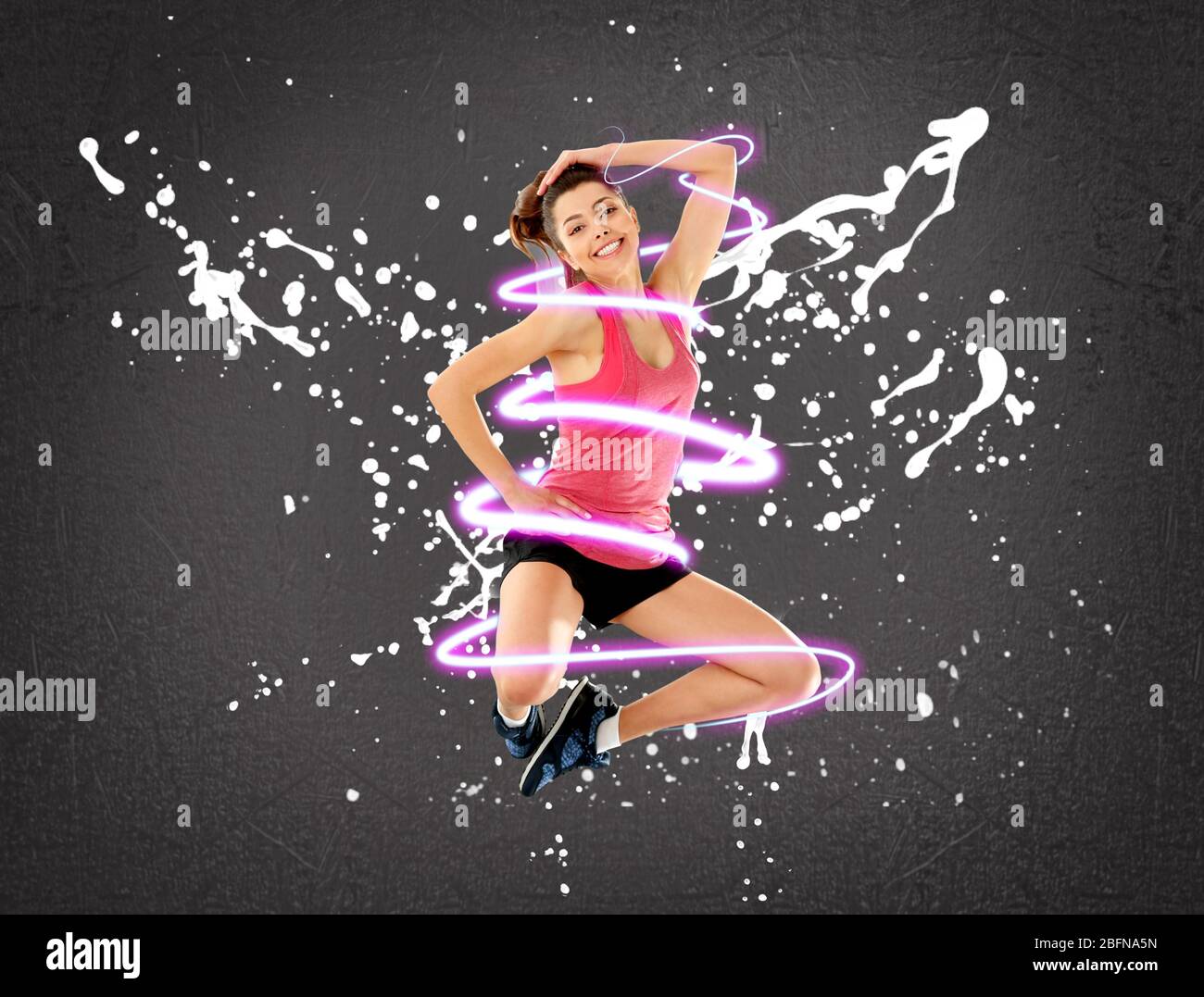 Young sporty woman jumping. Creative art work Stock Photo - Alamy