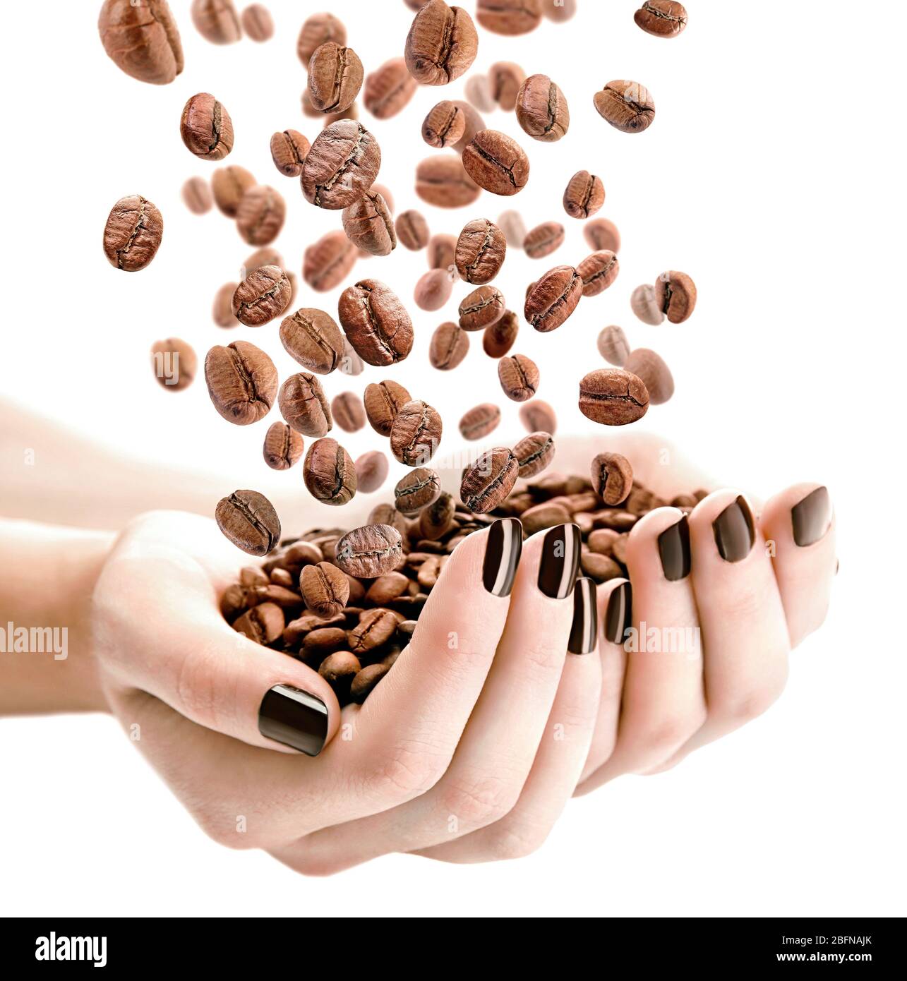 Roasted coffee beans falling into female hands on white background ...