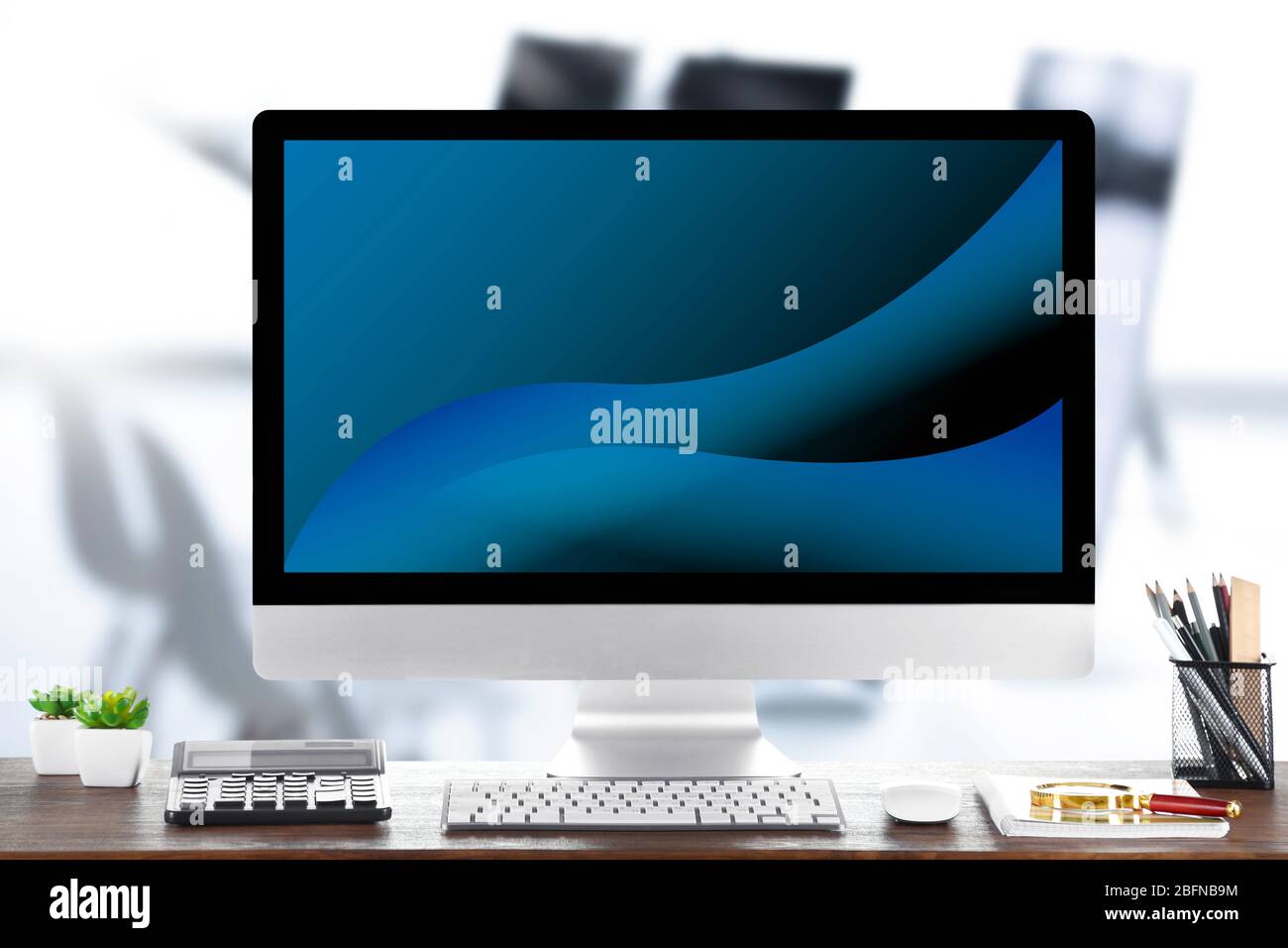 Modern workplace with computer. Wallpaper on screen Stock Photo - Alamy
