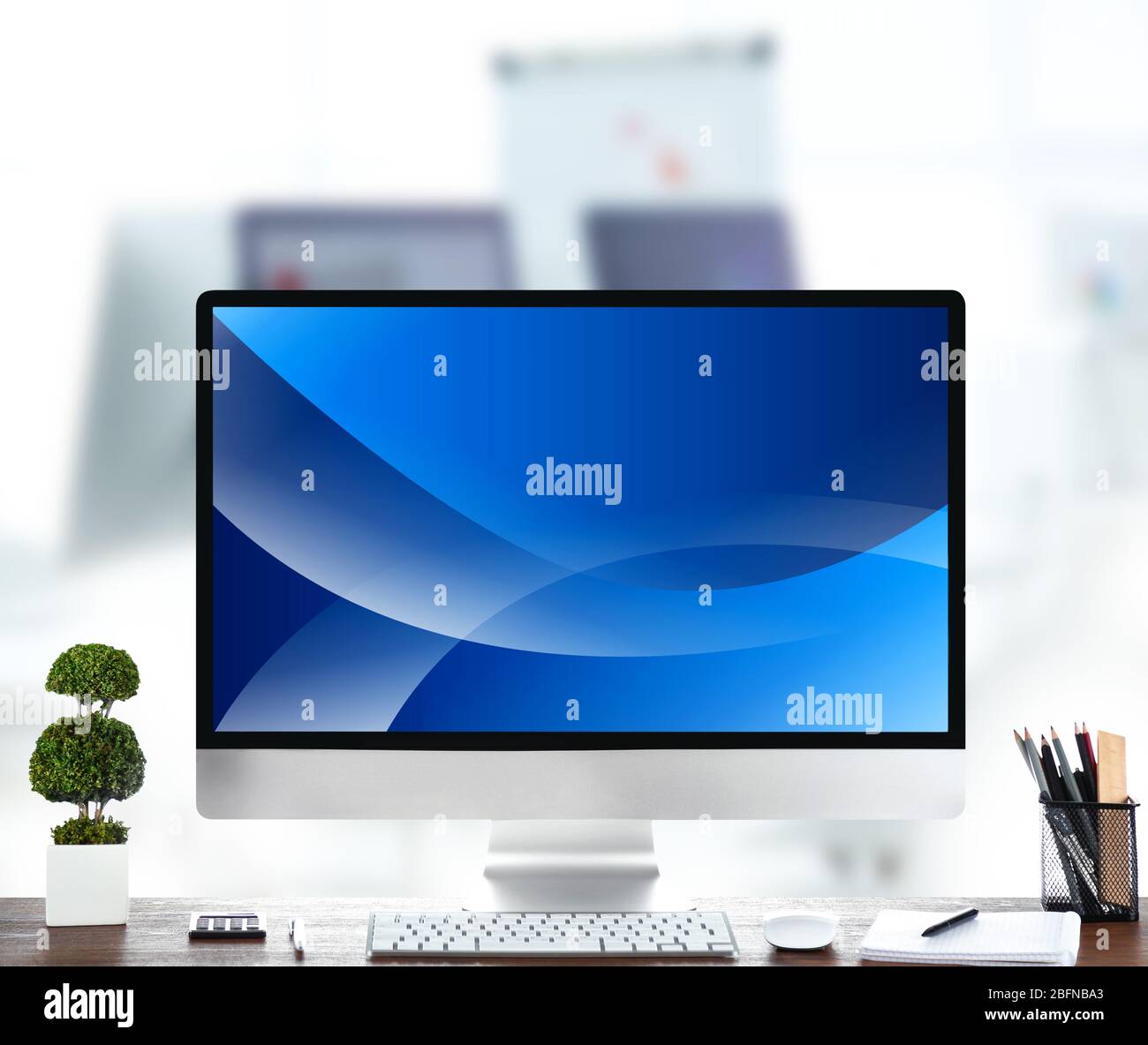 Modern workplace with computer. Wallpaper on screen Stock Photo - Alamy