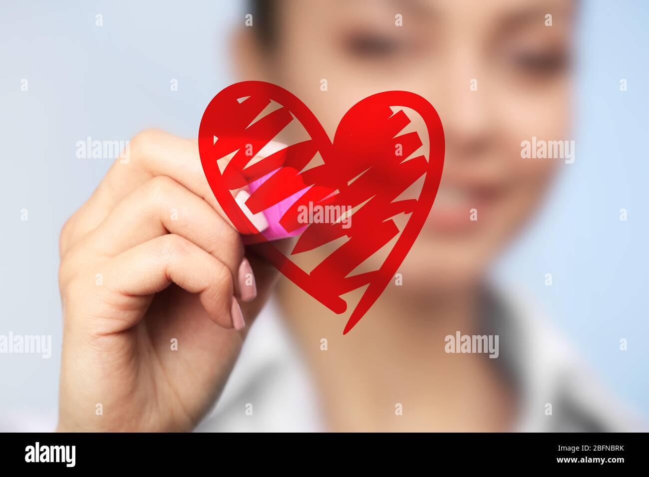 Cardiologist drawing heart, closeup. Cardiology concept Stock Photo - Alamy