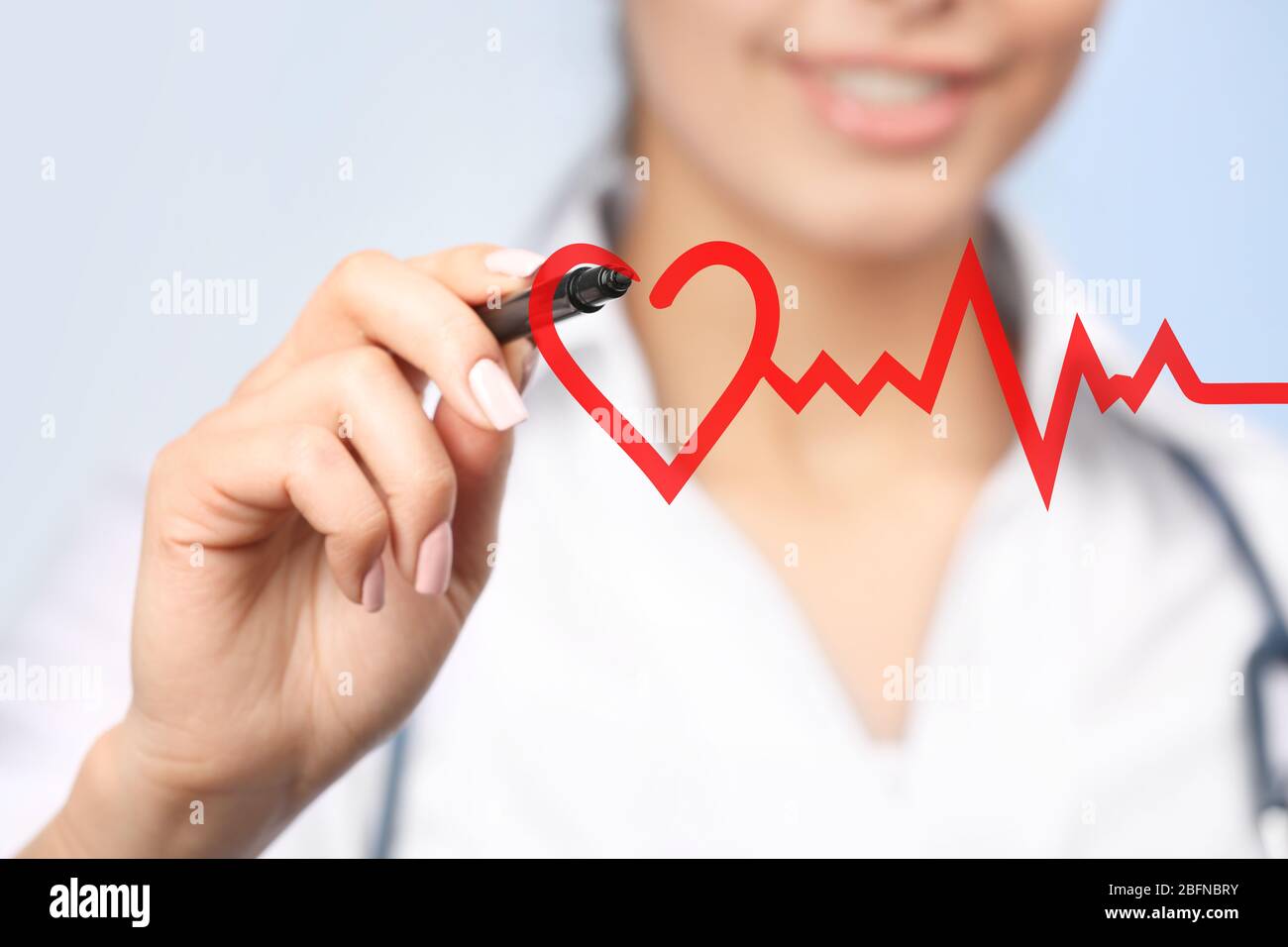 Cardiologist drawing heart, closeup. Cardiology concept Stock Photo - Alamy