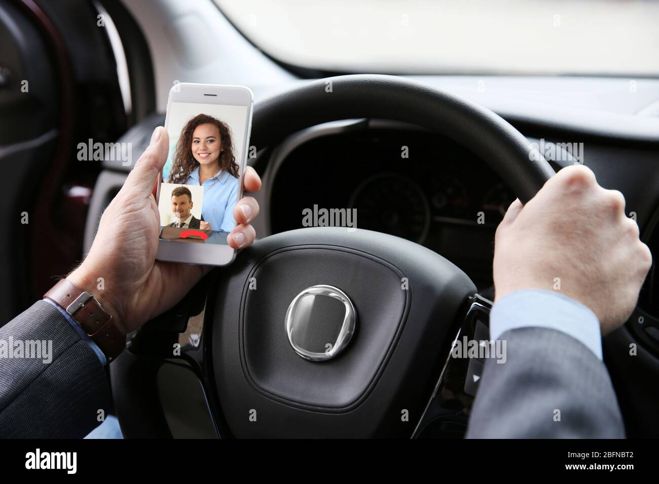 Man video conferencing on smartphone in car. Modern technology concept ...
