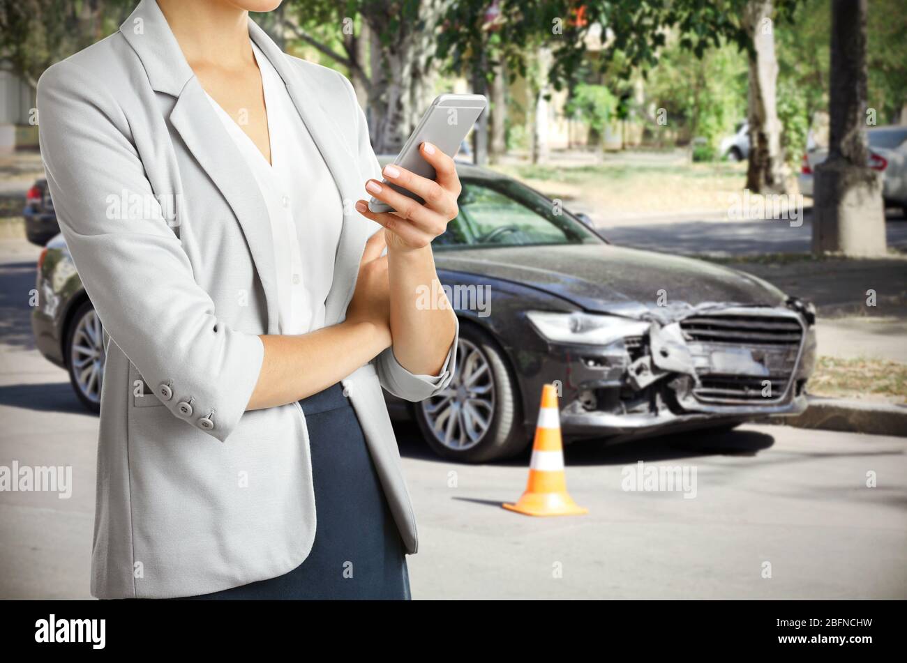 Woman using phone after car accident, closeup. Traffic safety concept ...