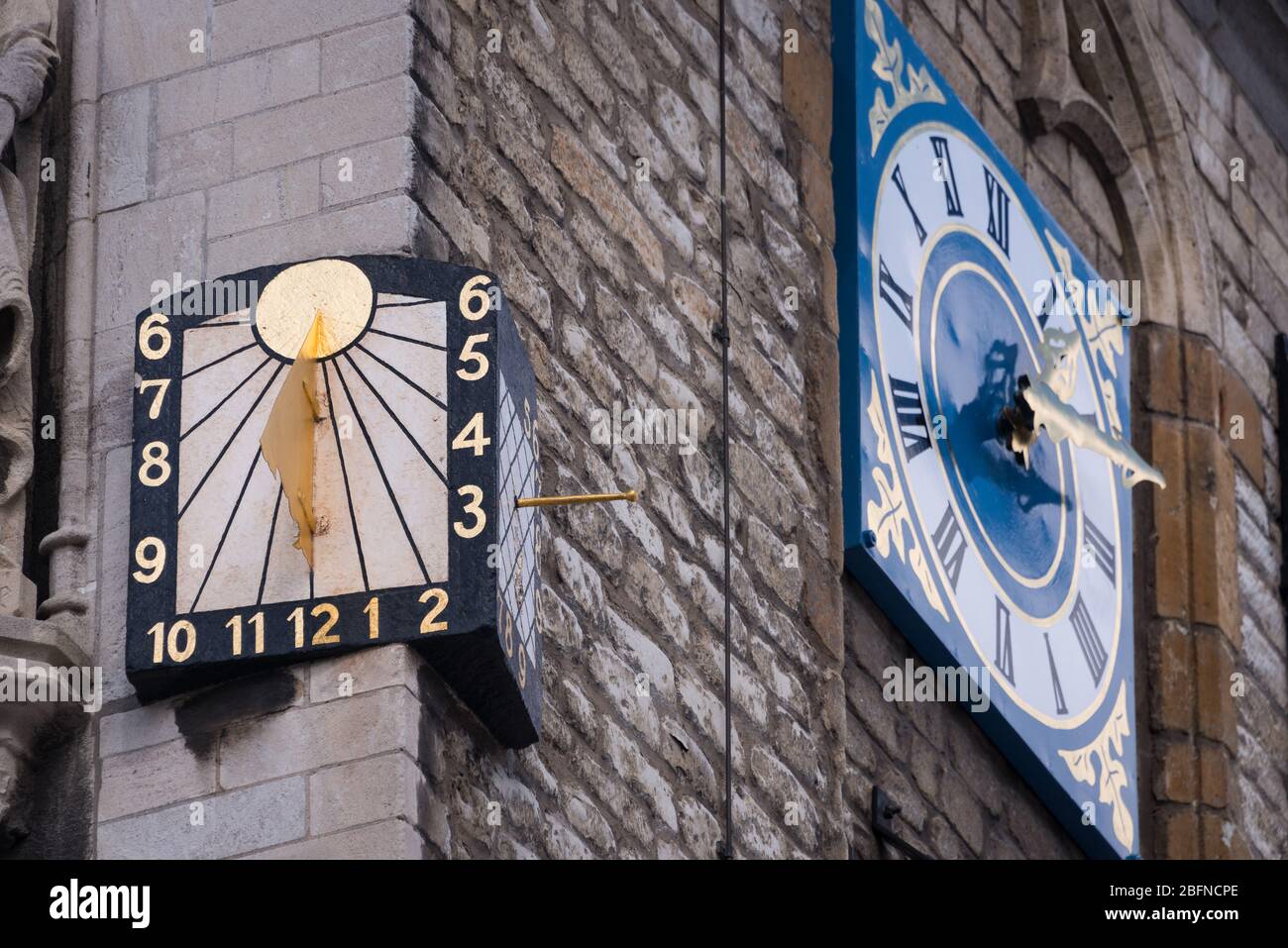 Gouda, Netherlands - April 2015: Sundial and clock in the town square ...