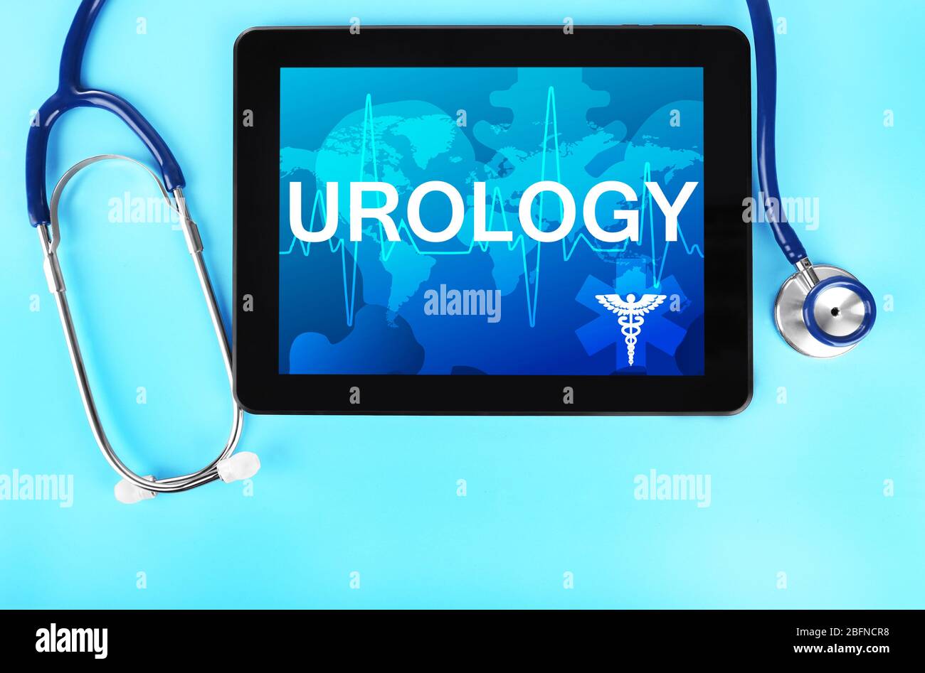Tablet and stethoscope on blue background. Word UROLOGY on screen ...