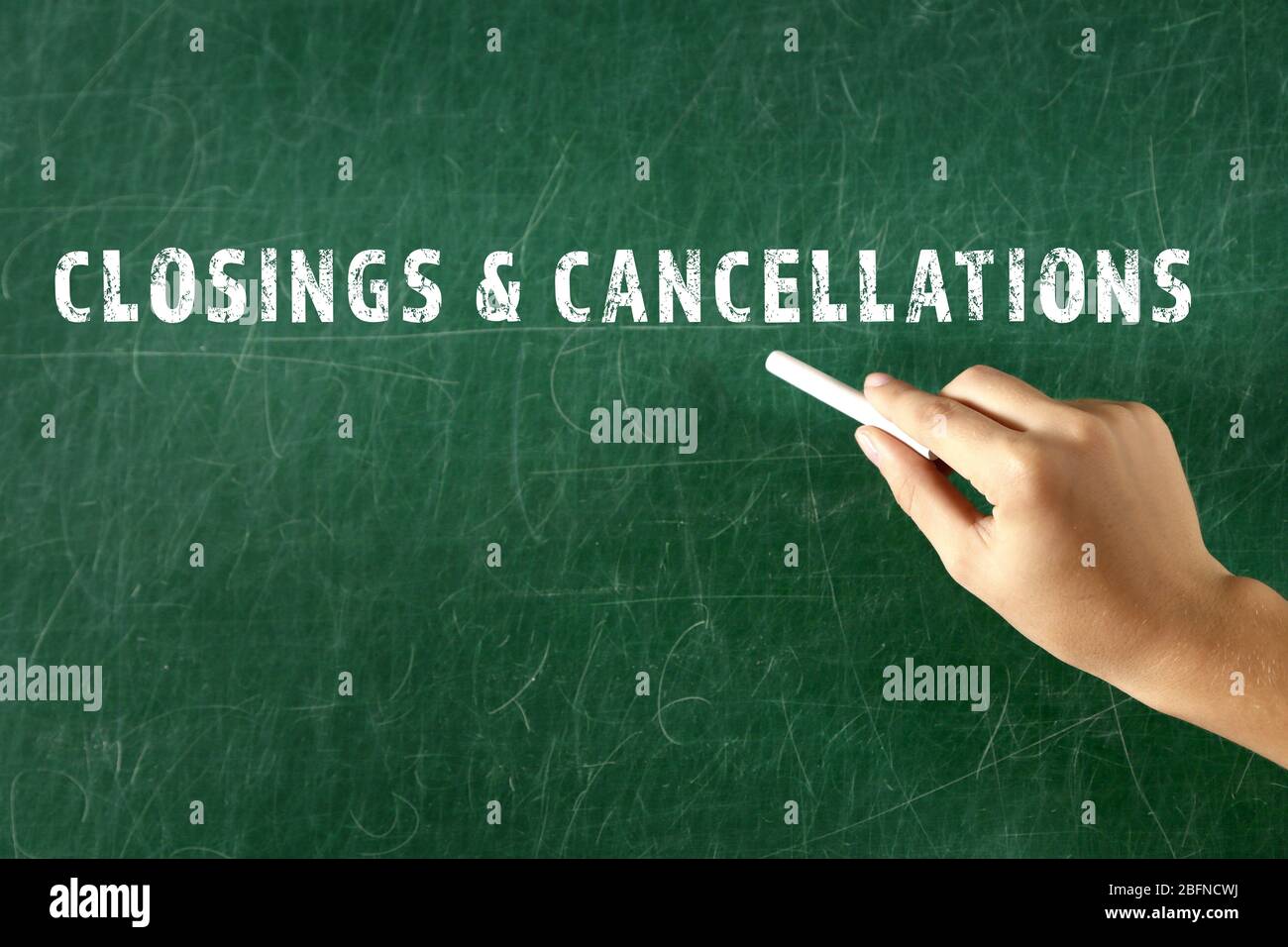 Text CLOSINGS and CANCELLATIONS, female hand with piece of chalk on ...