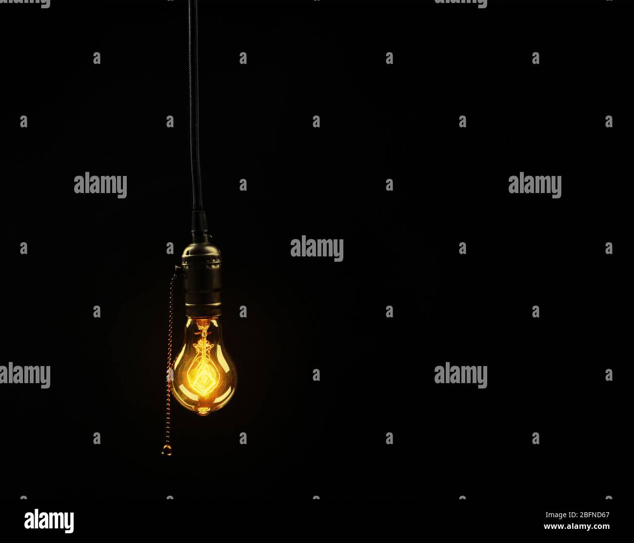 Light bulb on black background Stock Photo - Alamy