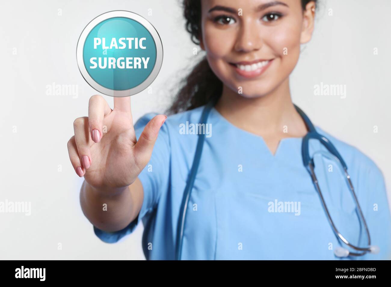 Woman pushing PLASTIC SURGERY button on virtual screen Stock Photo - Alamy