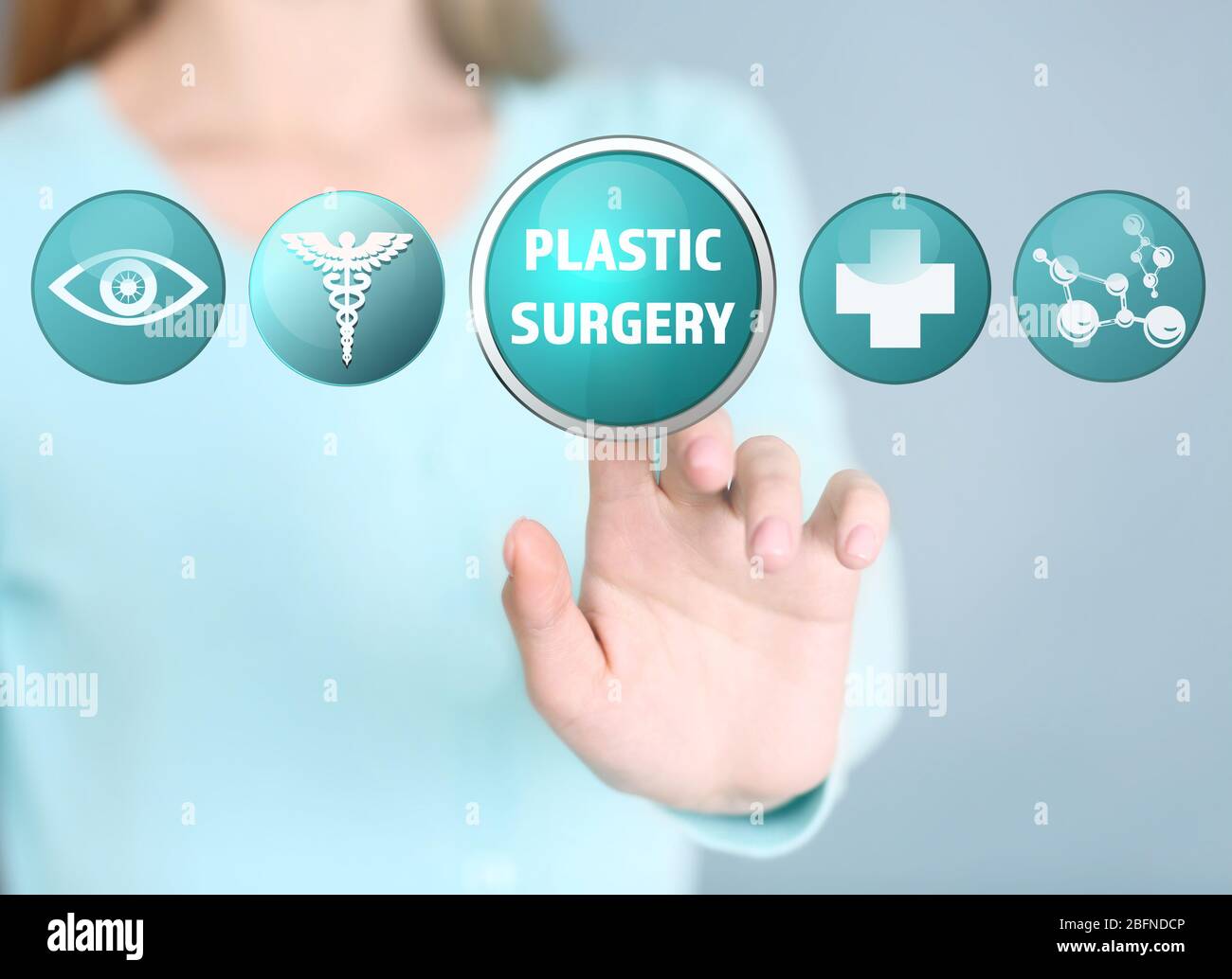 Woman pushing PLASTIC SURGERY button on virtual screen Stock Photo - Alamy