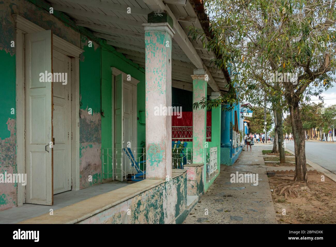 Typical rundown scene of peeling paint on pillared buildings on ...