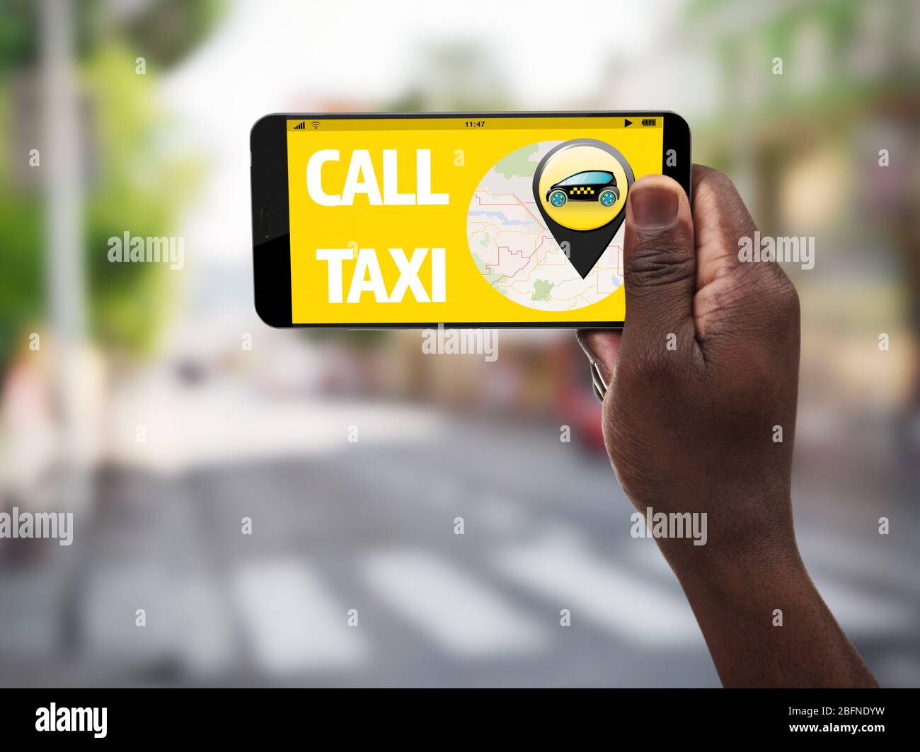 Male hand with smartphone on blurred road background. Taxi service ...