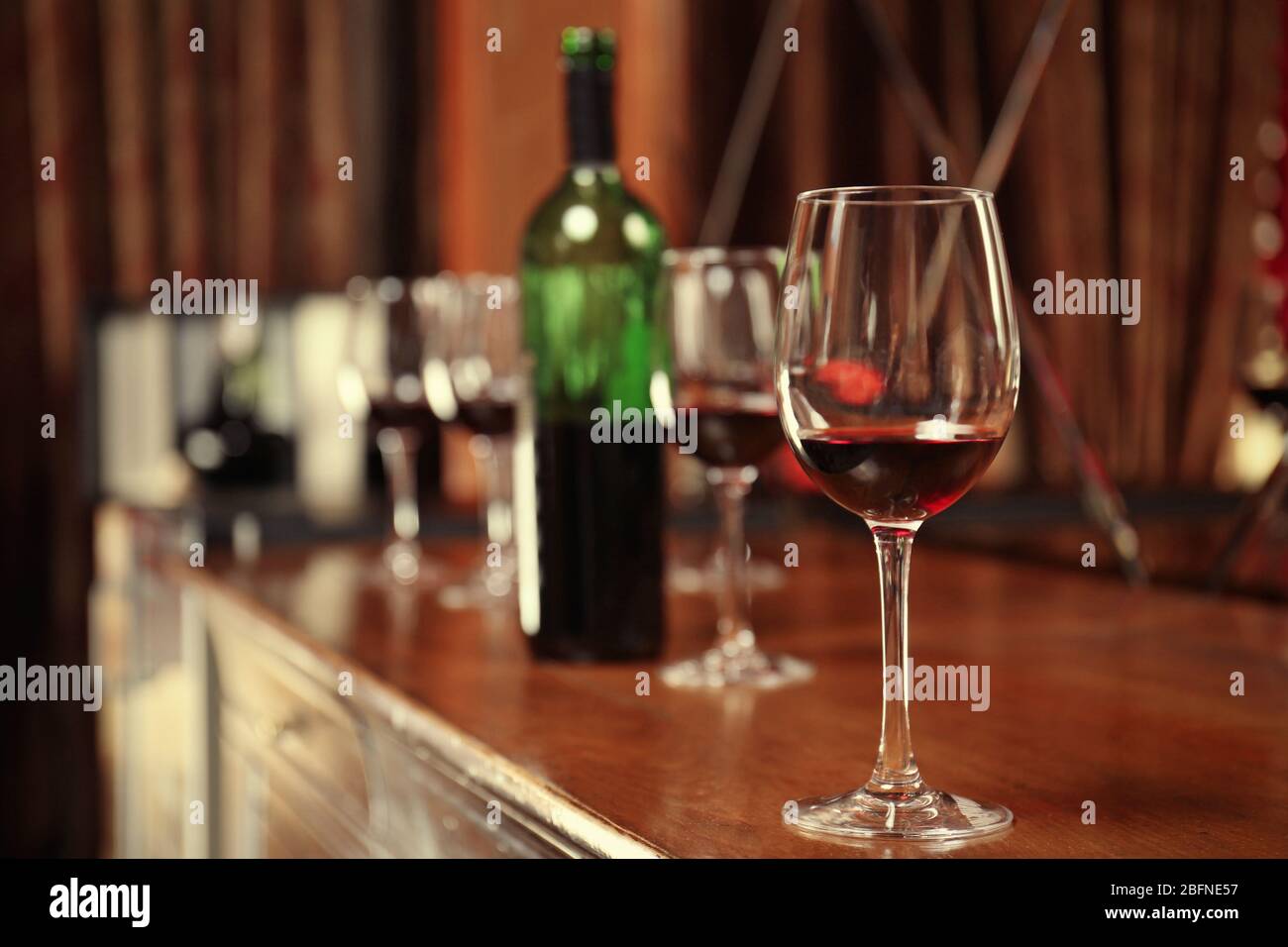 Glass of red wine on bar counter Stock Photo - Alamy