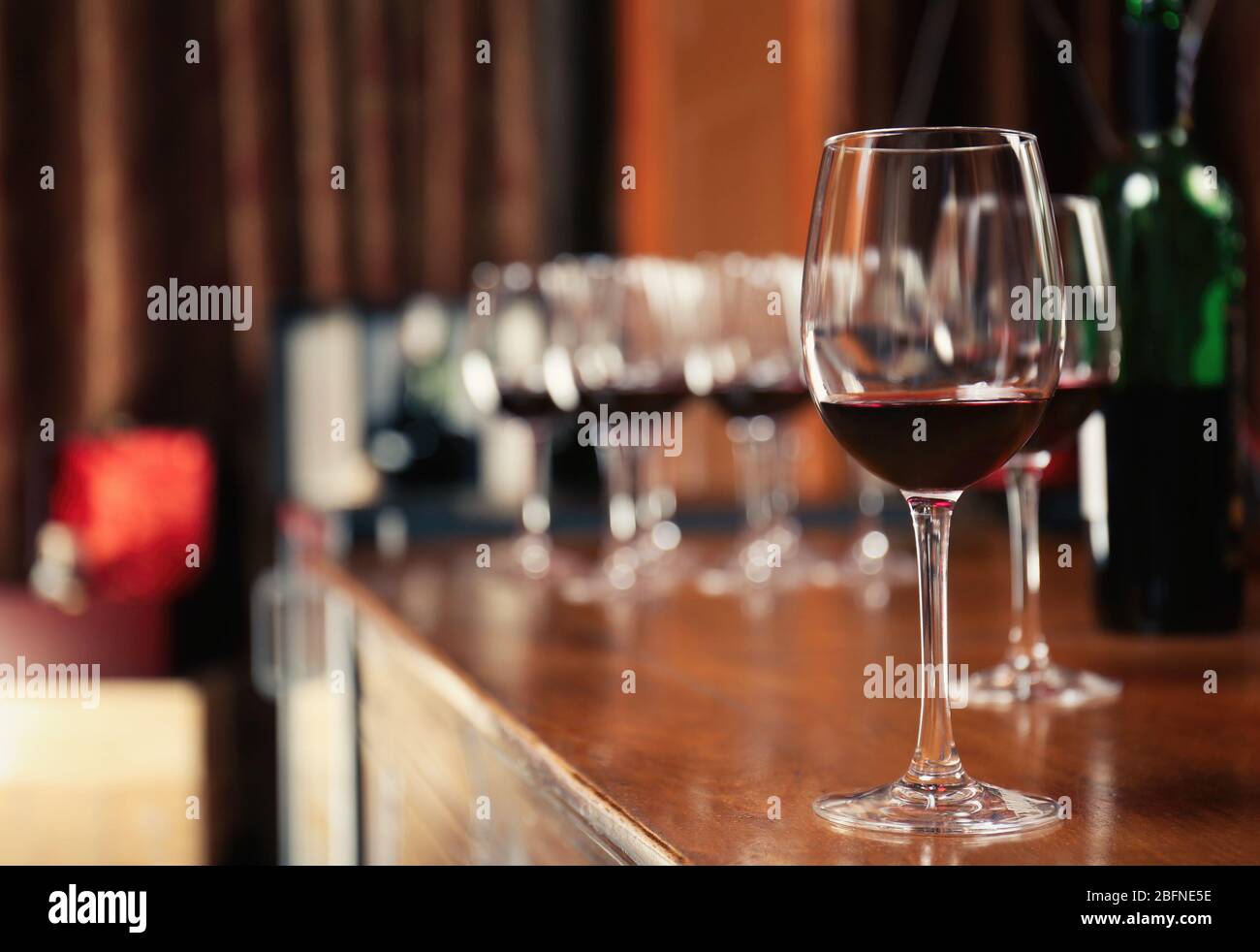 Glass of red wine on bar counter Stock Photo - Alamy