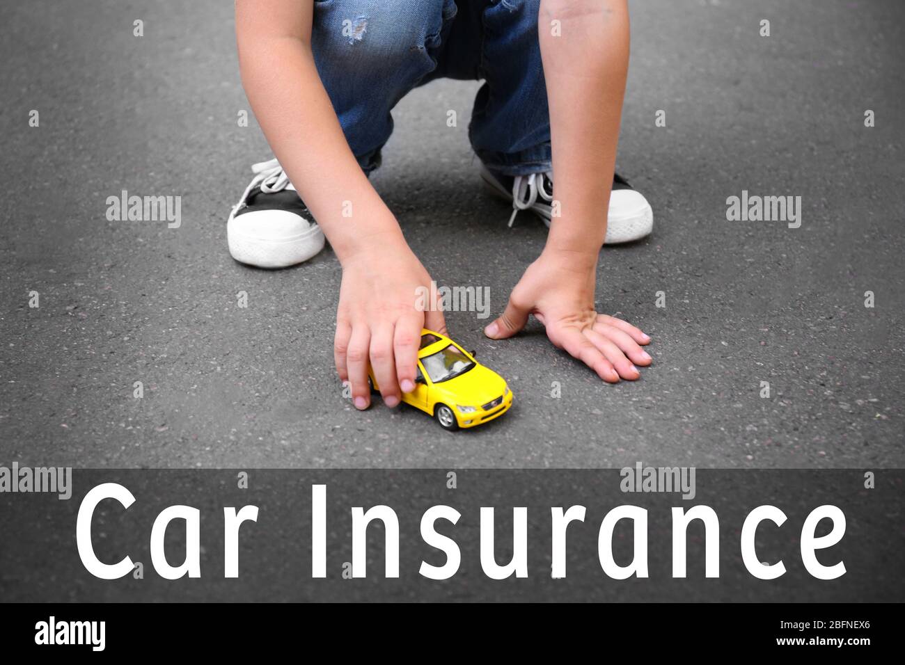 Car insurance concept. Little boy playing with toy car on street Stock ...