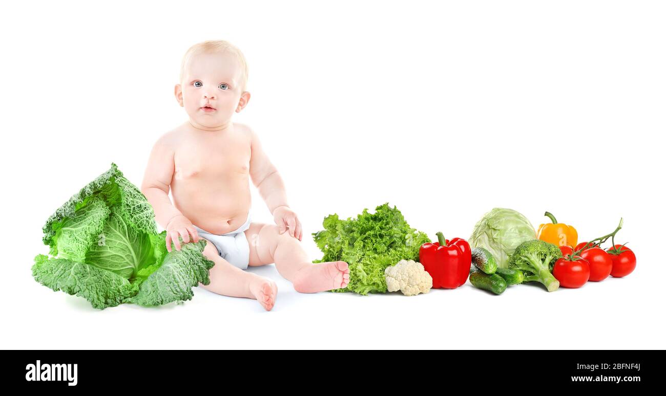 Cute baby with vegetables on white background Stock Photo - Alamy