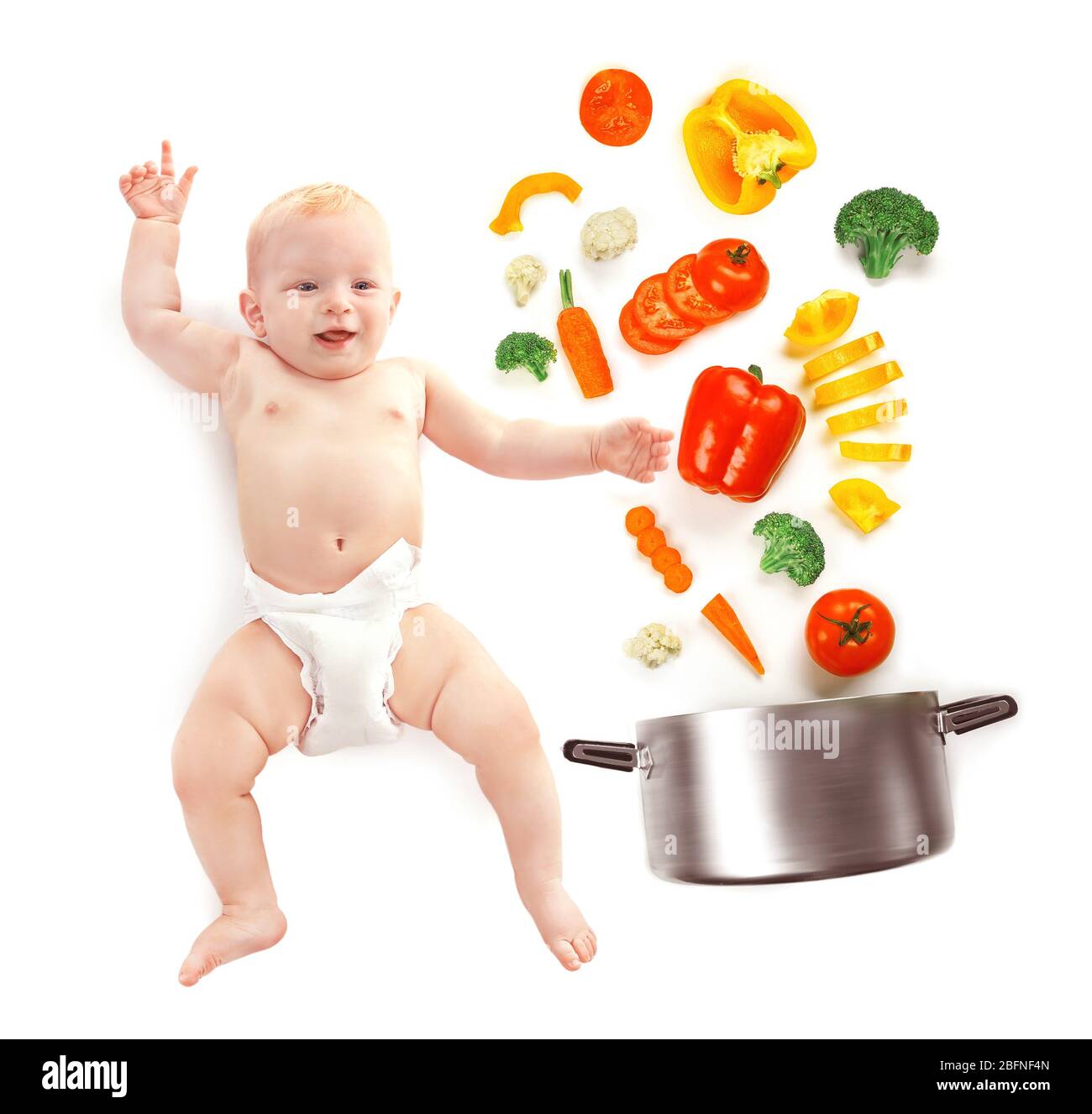 Cute baby with sliced vegetables and saucepan on white background Stock ...