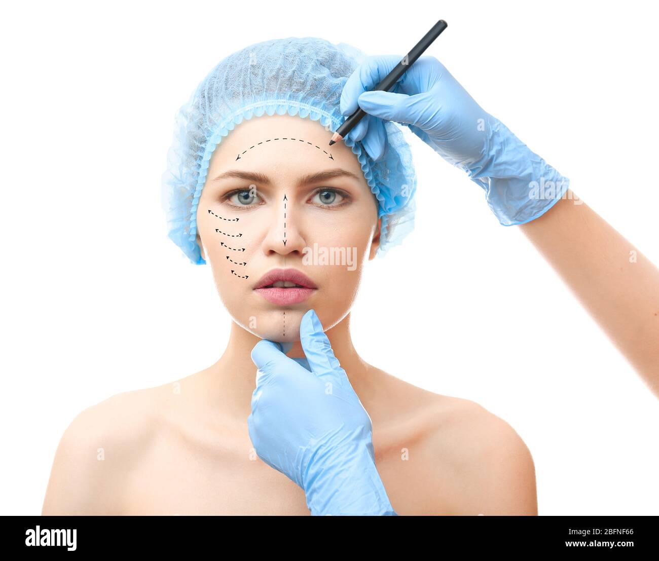 Plastic surgery concept. Doctor drawing marks on female face against ...