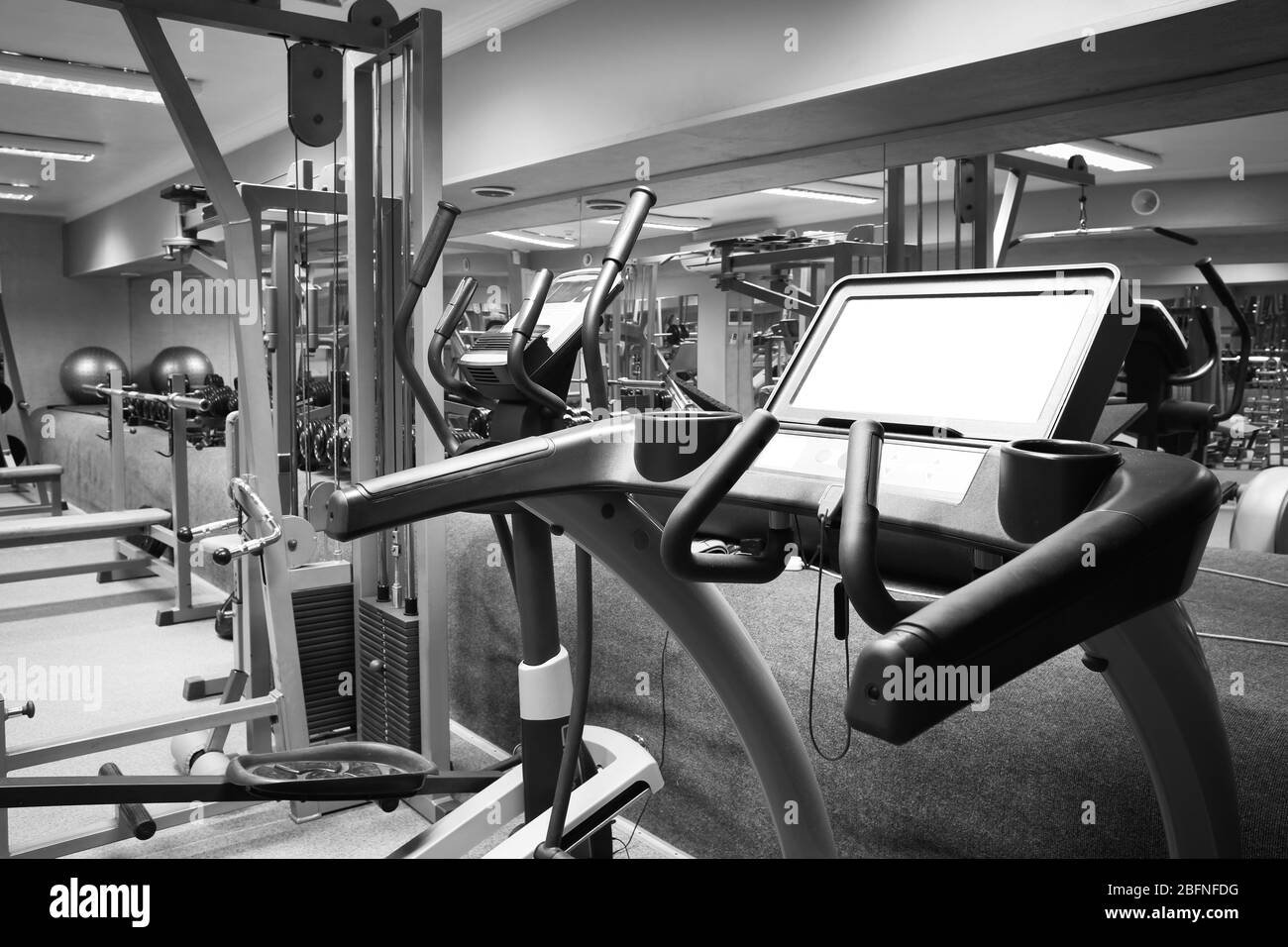 Modern equipment in gym. Black and white photo Stock Photo - Alamy