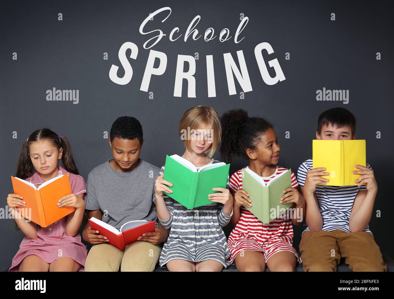 Text SCHOOL SPRING and children with books on dark background ...