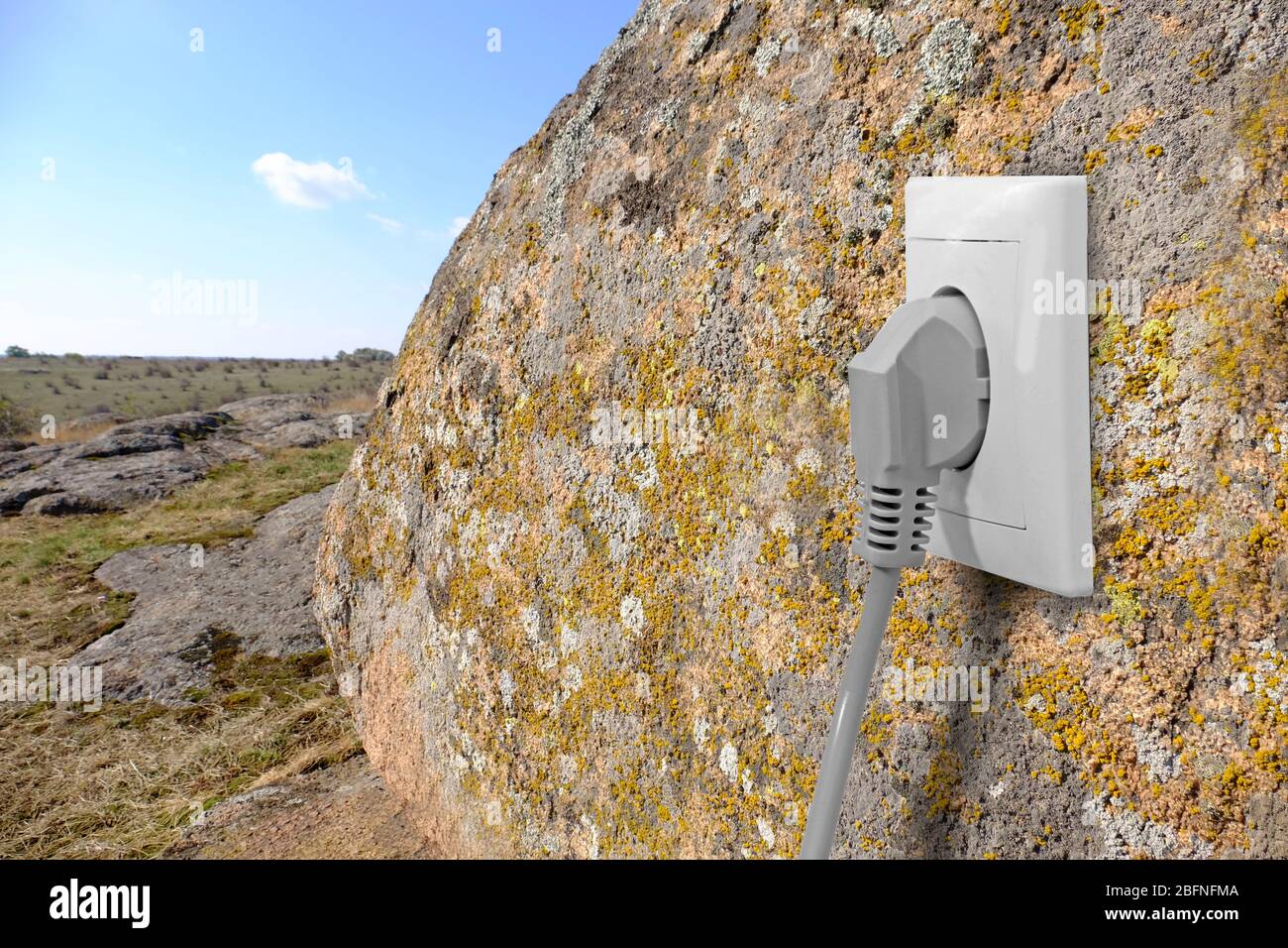 Socket with plug on rock Stock Photo - Alamy