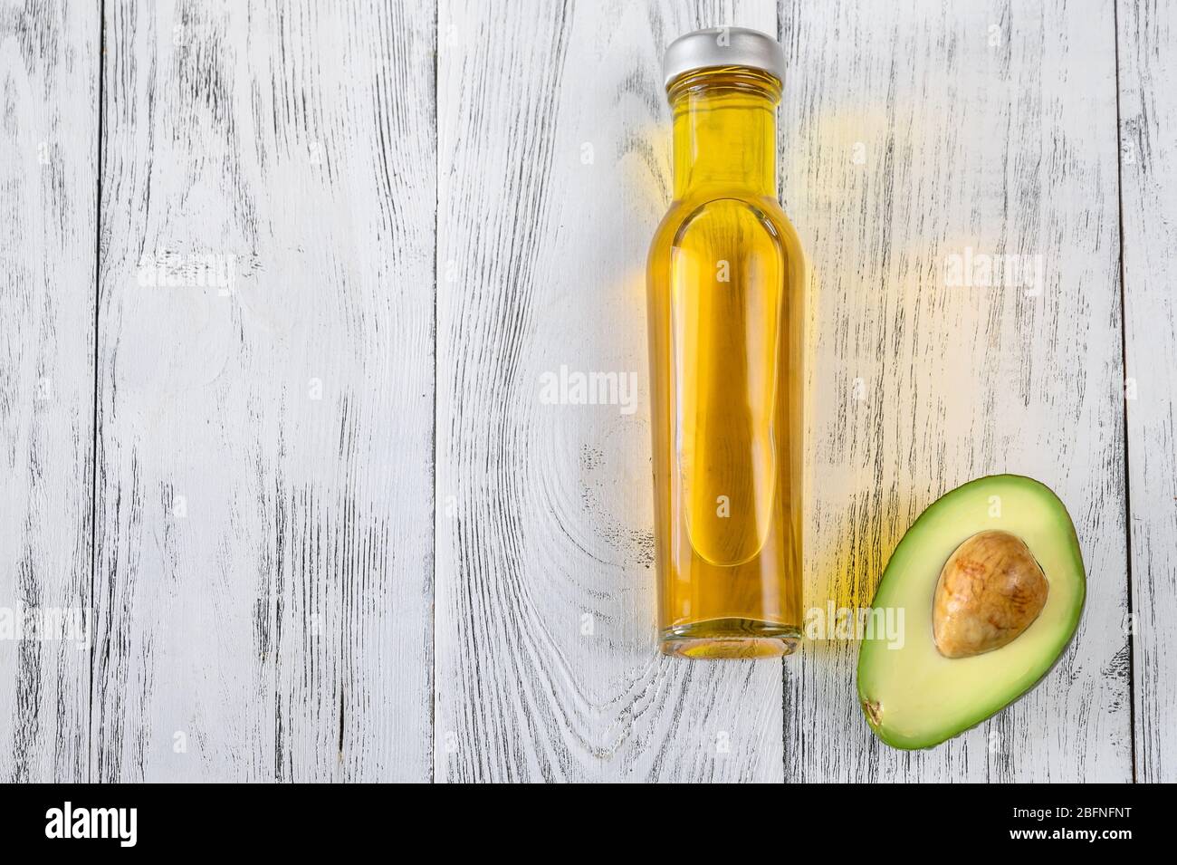 Bottle of avocado oil with fresh avocado: top view Stock Photo - Alamy