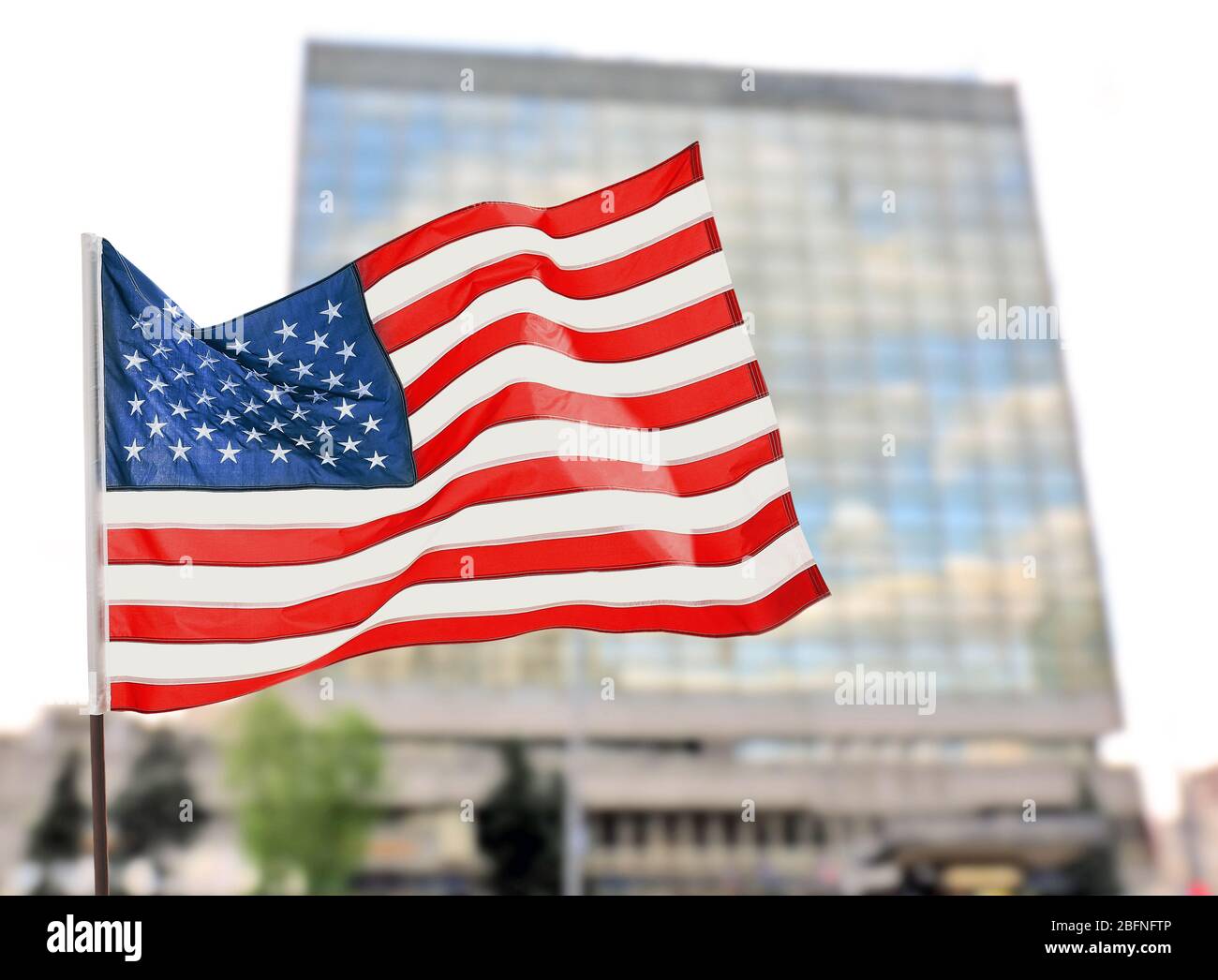 American flag on blurred building background Stock Photo - Alamy