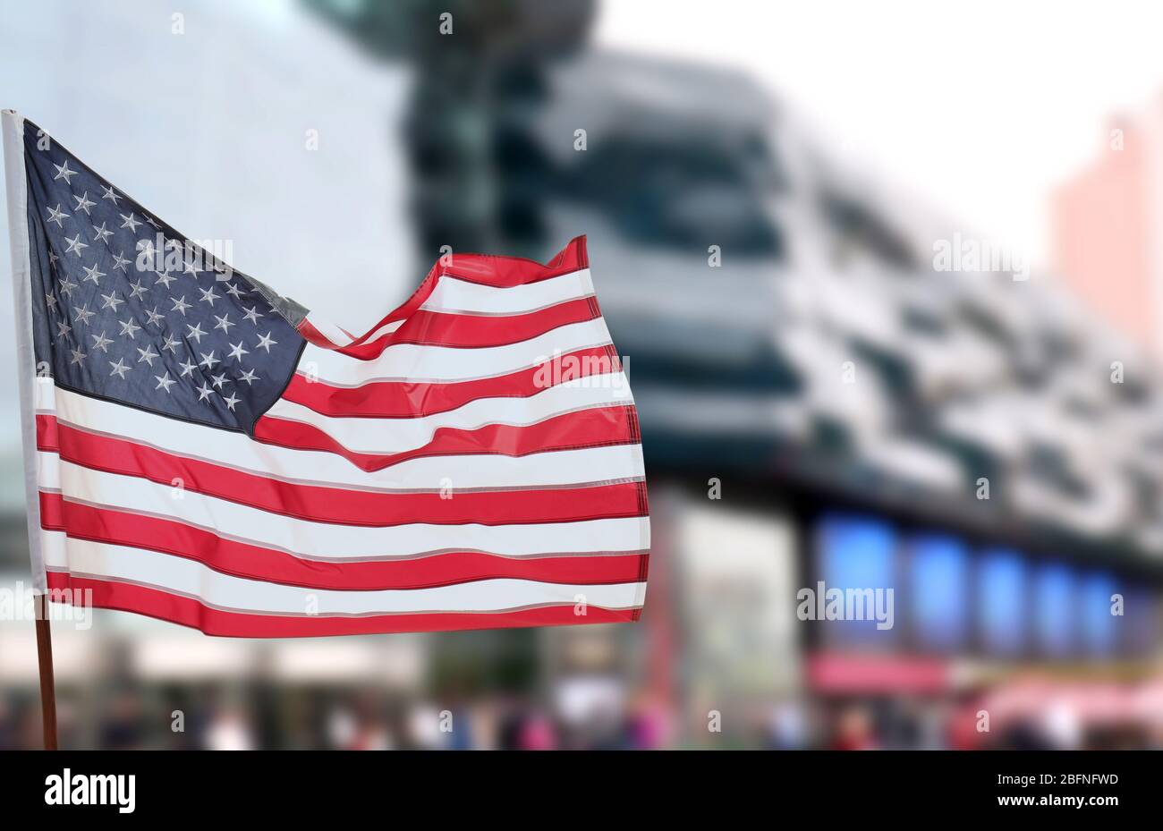 American flag on blurred building background Stock Photo - Alamy