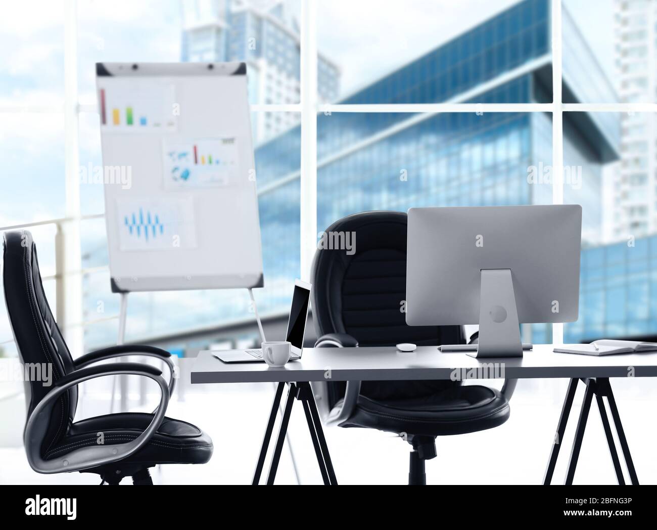 Modern office interior and cityscape view through window Stock Photo ...