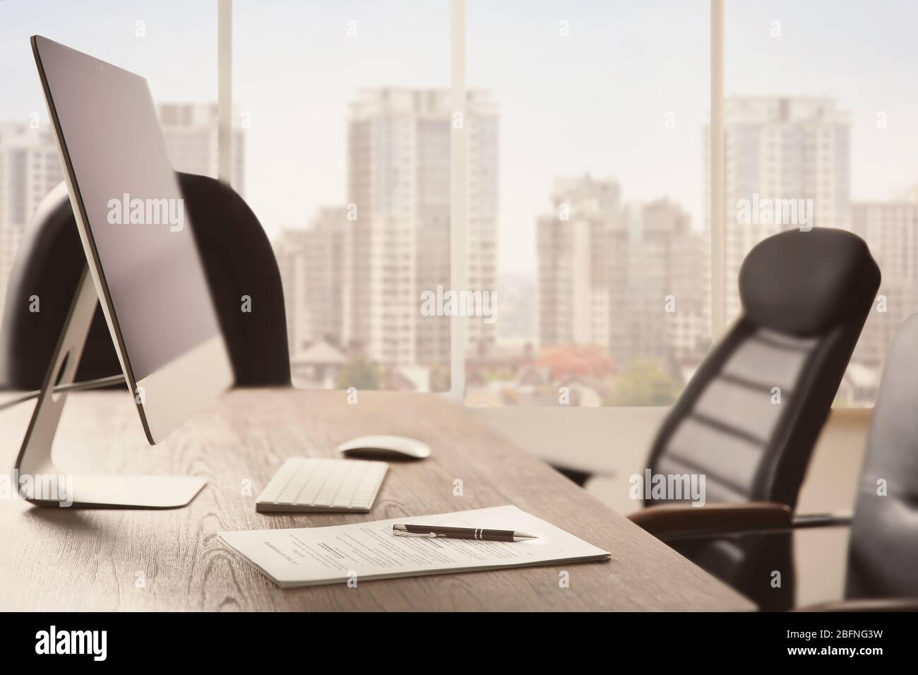 Modern office interior and cityscape view through window Stock Photo ...