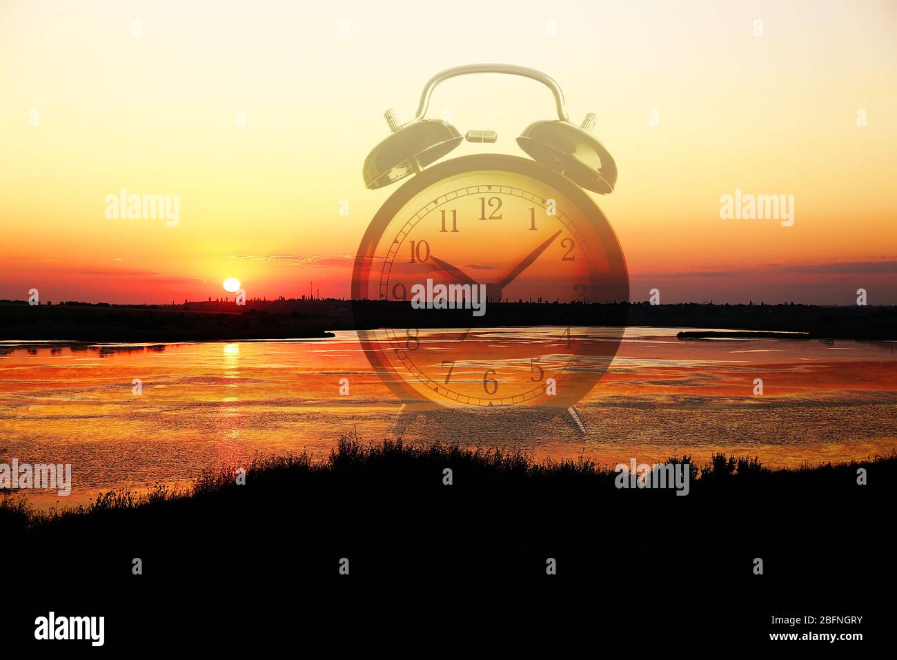 Time change concept. Double exposure of alarm clock and landscape ...