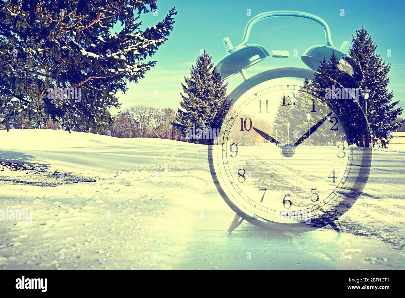 Time change concept. Double exposure of alarm clock and winter ...