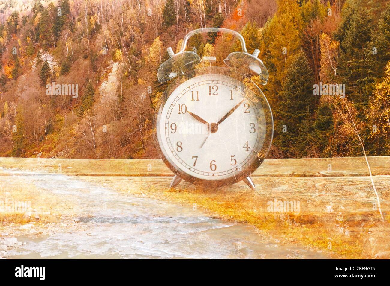 Time change concept. Double exposure of alarm clock and landscape ...