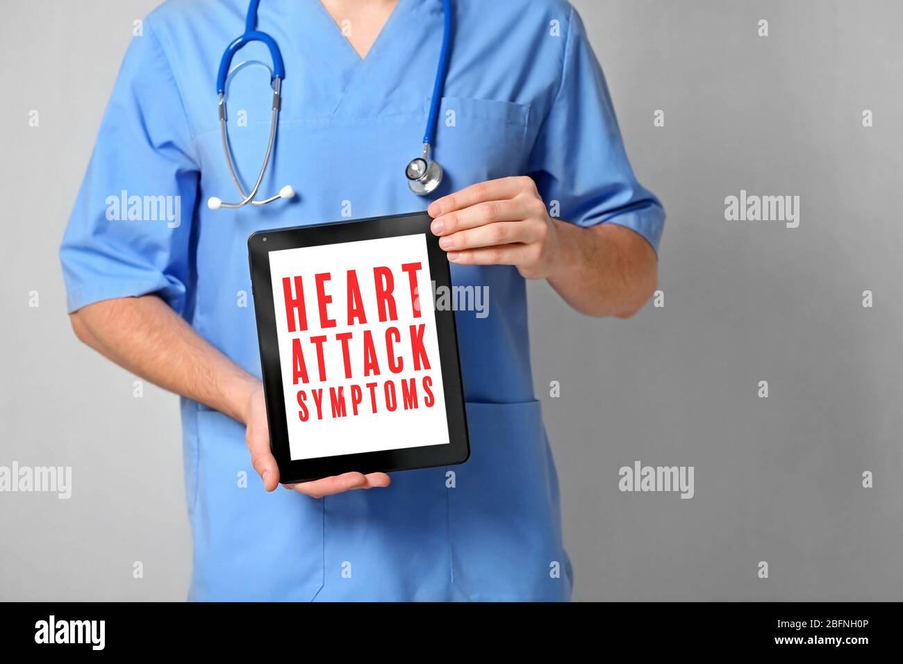 Cardiology and health care concept. Doctor's hands holding tablet with ...