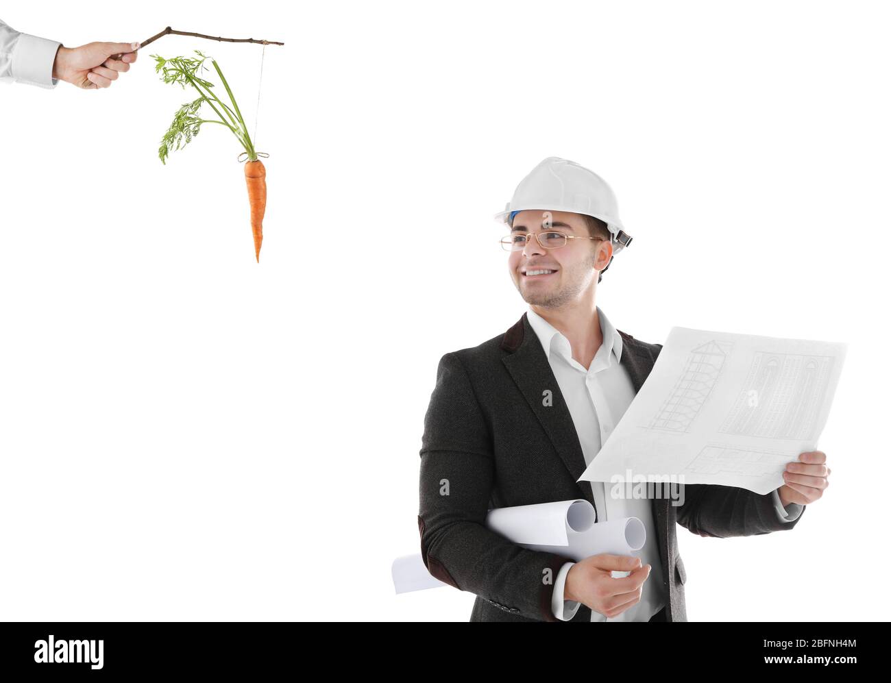 Motivation and goal concept. Young man looking at carrot, white ...