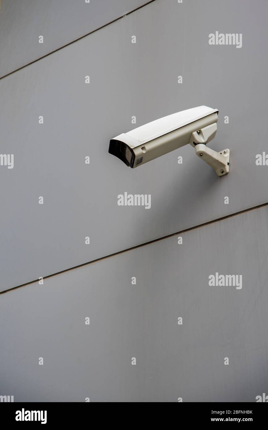 Urban security camera on the wall Stock Photo - Alamy