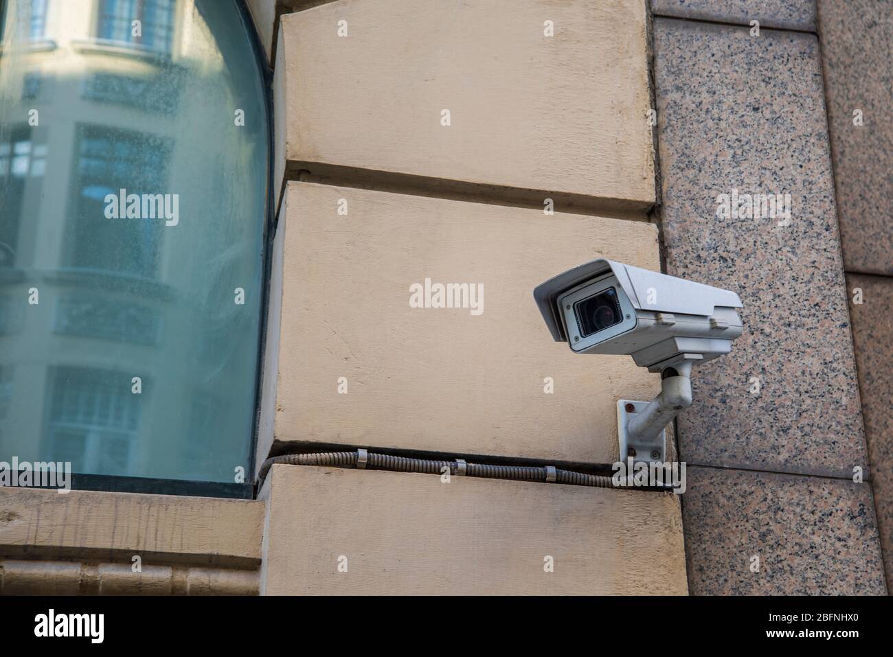 Urban security camera on the wall Stock Photo - Alamy