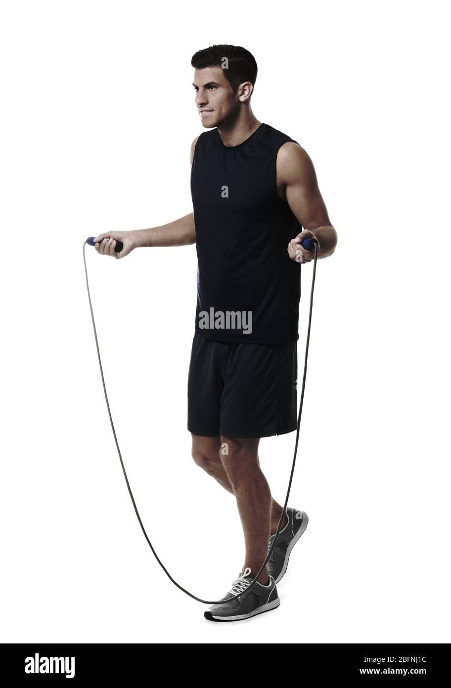 Young man with jumping rope on white background Stock Photo - Alamy