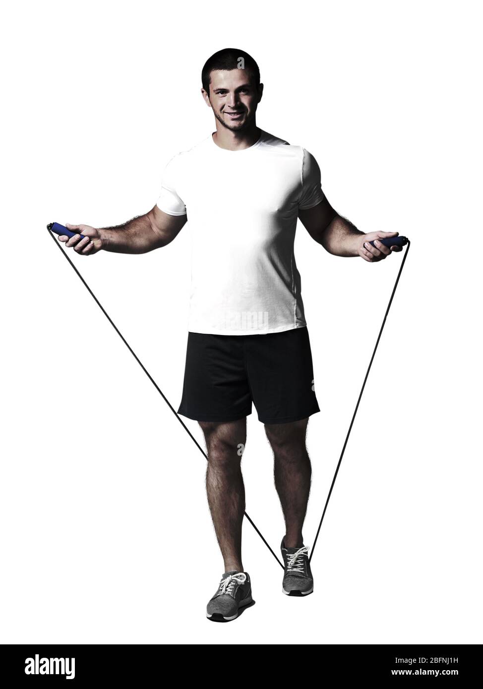 Young man with jumping rope on white background Stock Photo - Alamy