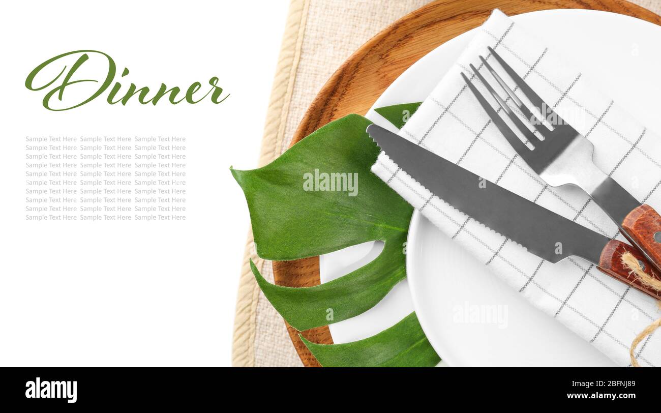 Table setting and word DINNER on white background Stock Photo - Alamy