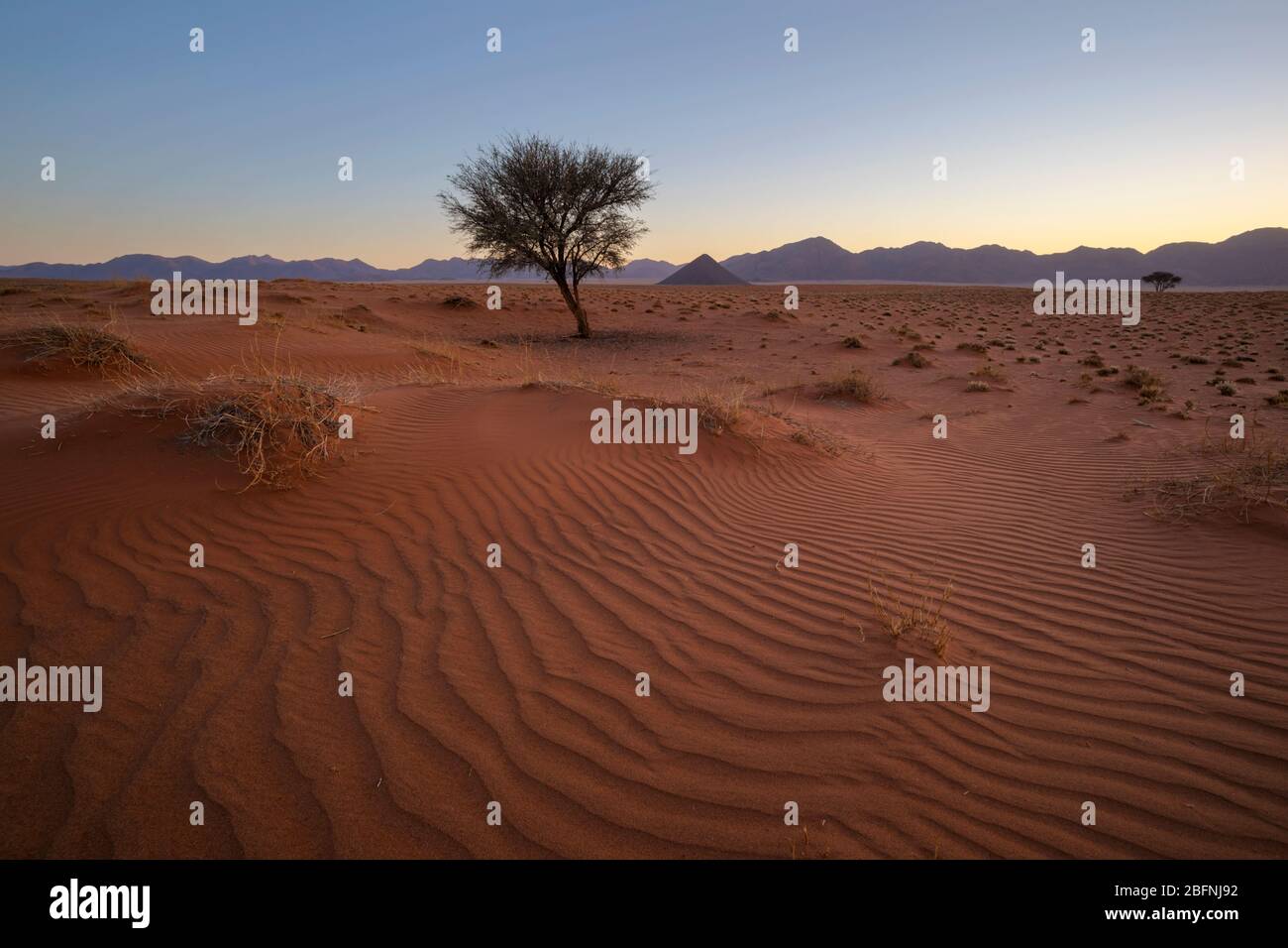 Red sand and blue mountains Stock Photo - Alamy