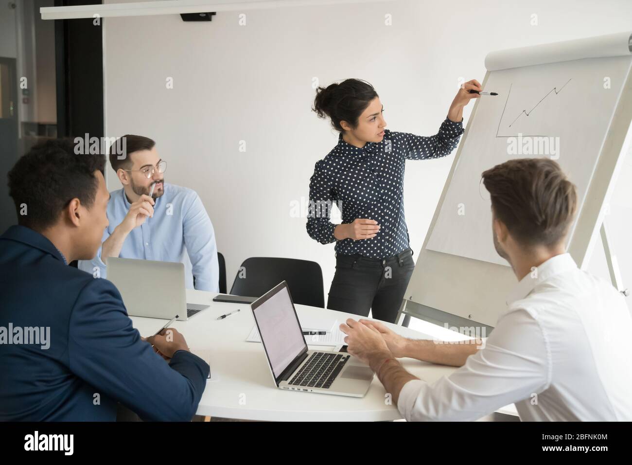 Diverse business people listens indian coach during corporate training ...