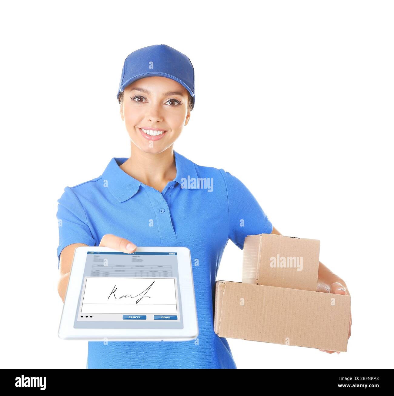 Delivery woman in uniform with tablet and parcels on white background ...