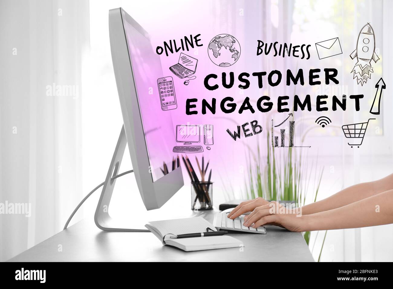 Woman working with computer at table. Concept of customer engagement ...