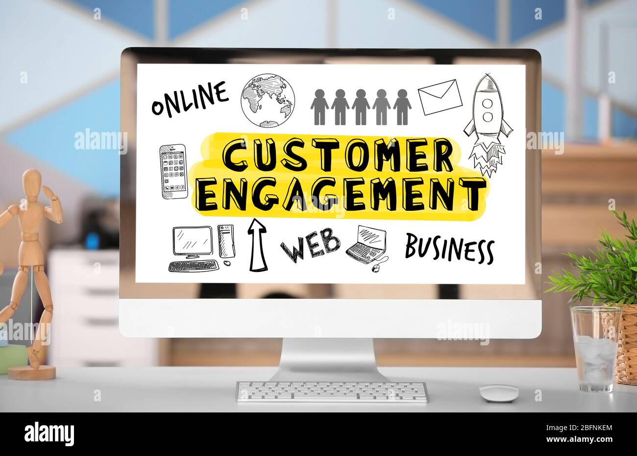 Workplace with computer and text CUSTOMER ENGAGEMENT on screen Stock ...