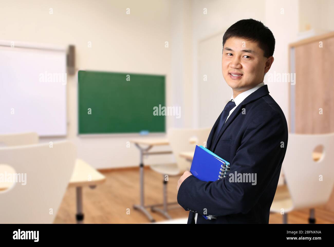 Portrait of young teacher in modern class room at school Stock Photo ...