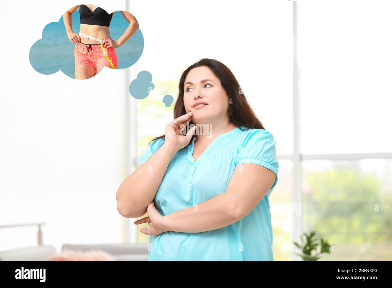 Overweight woman dreaming about slim body at home. Weight loss concept ...
