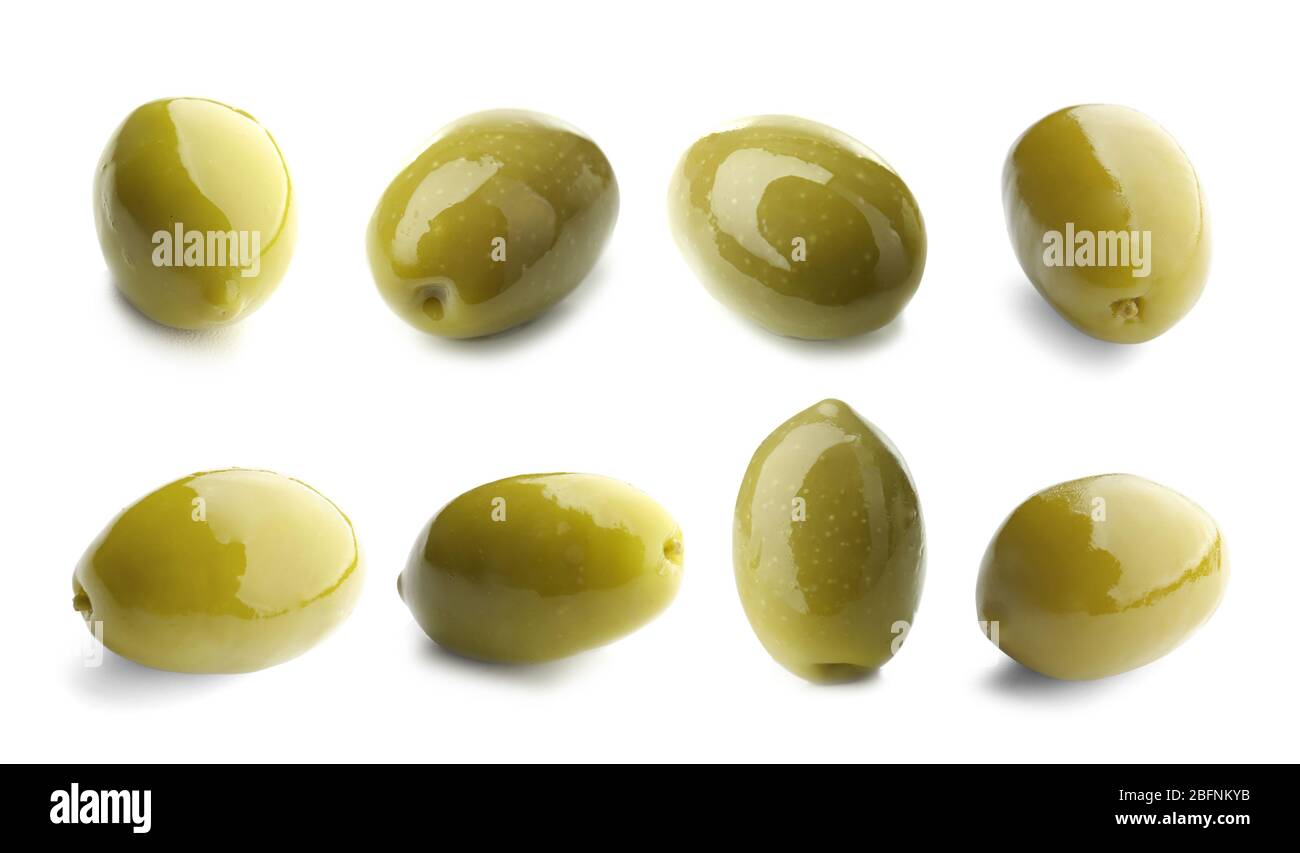 Green tasty olives on white background Stock Photo - Alamy
